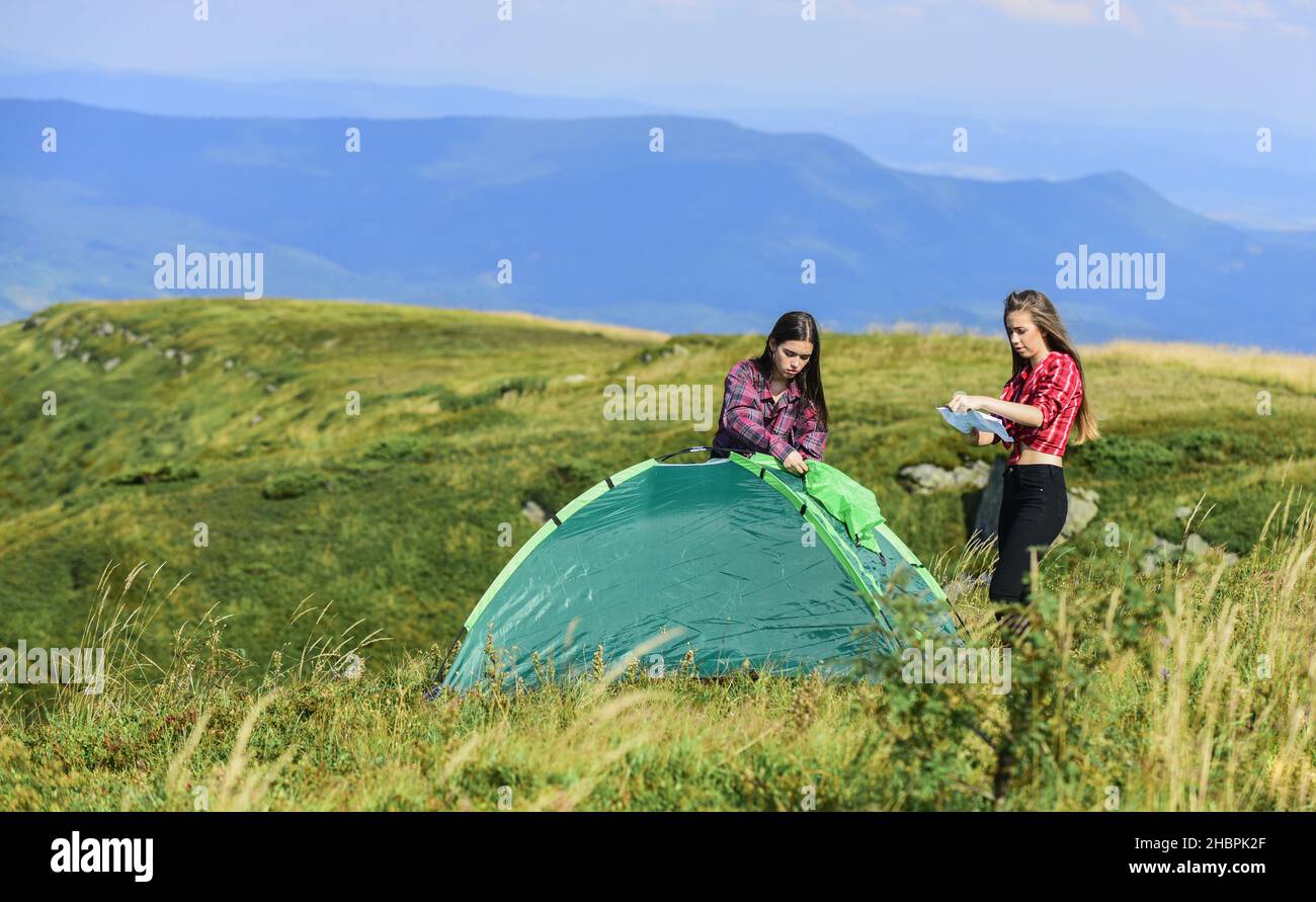 Follow instructions. Group friends set up tent on top mountain ...
