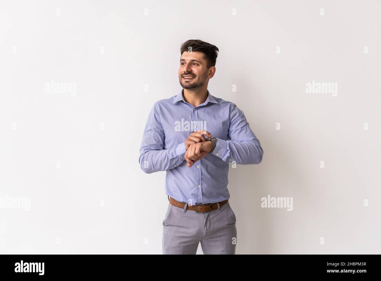 young business man looking at watch over white background Stock Photo ...
