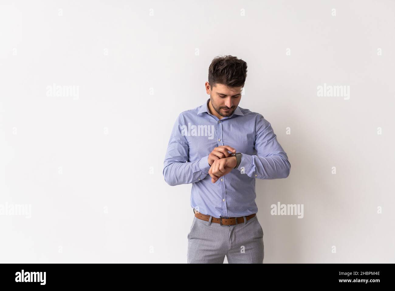 young business man looking at watch over white background Stock Photo ...