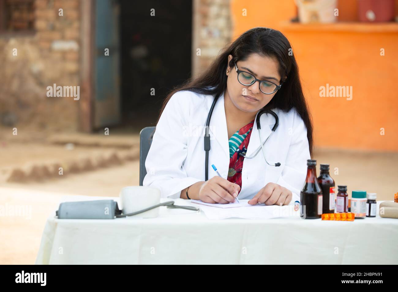 Young Indian Female Doctor wear Stethoscope writing prescription on ...