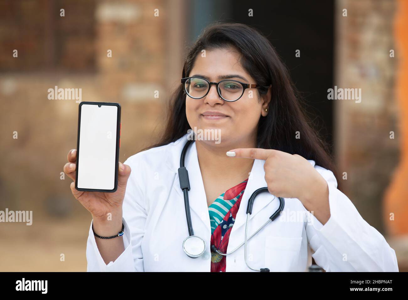 Young Positive Indian Female Doctor Wearing Stethoscope Showing Smart ...