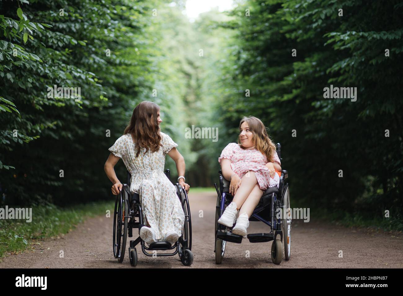 Young attractive women with physical disability enjoying time together ...