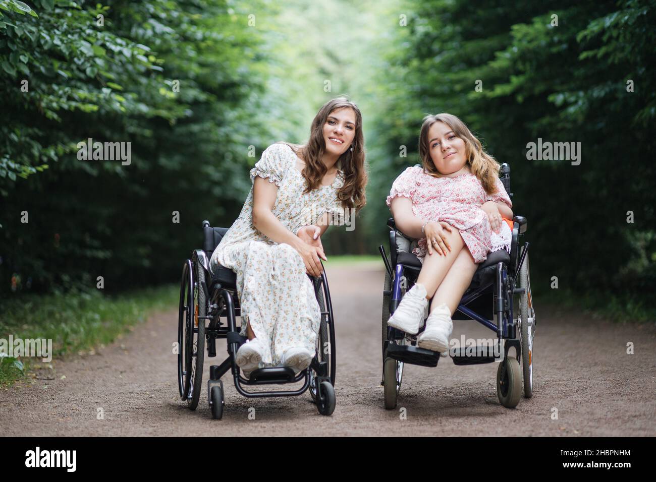 Happy young women with physical disability enjoying summer walk at ...