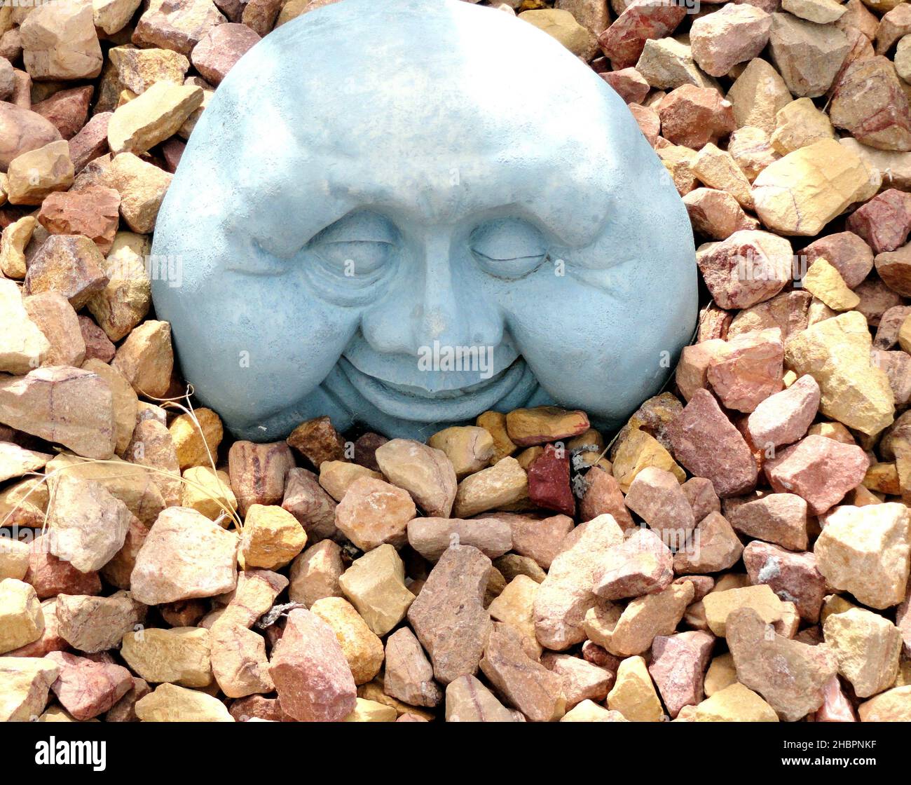 A funny stone with carved face on the rocks Stock Photo - Alamy