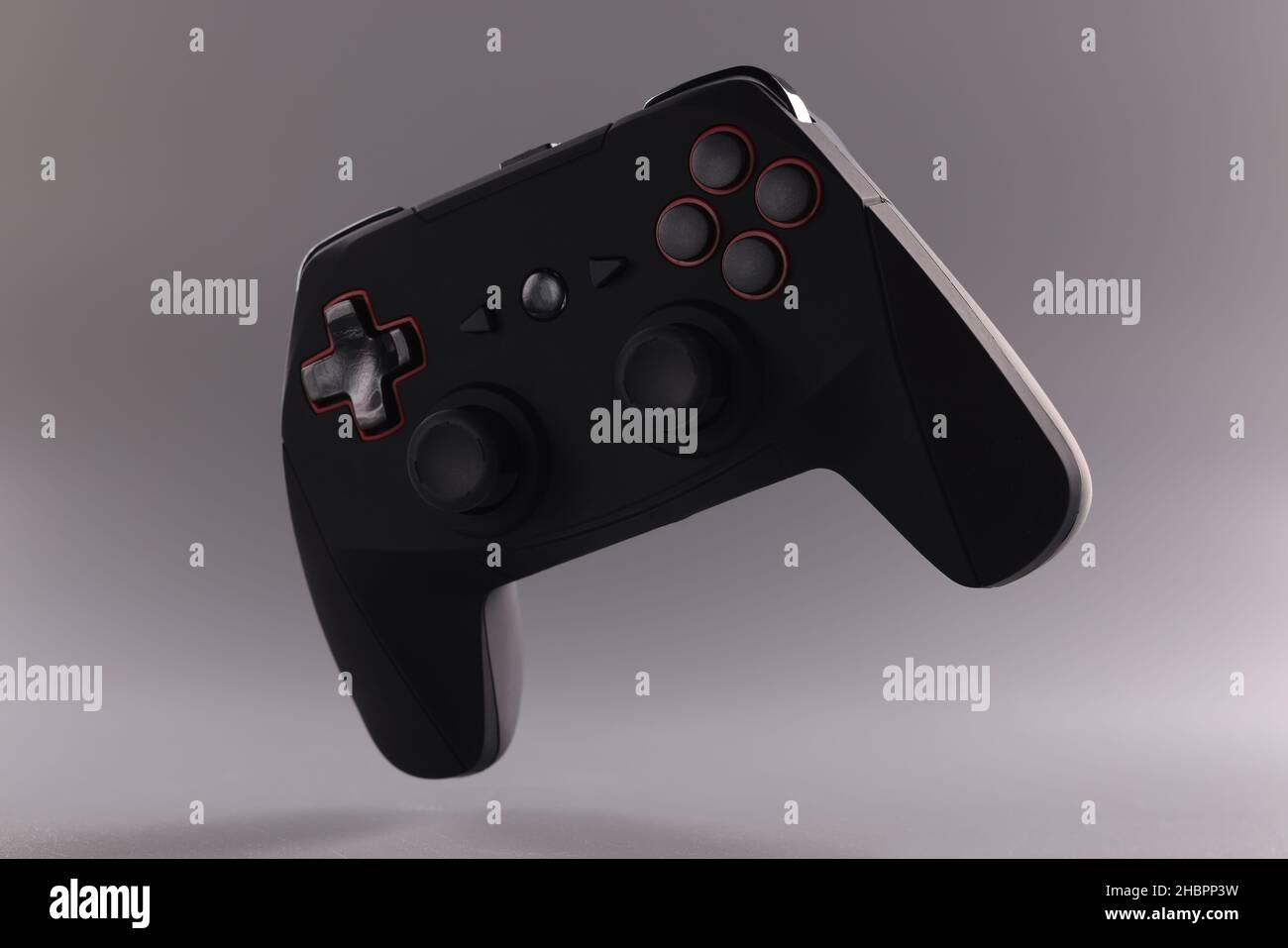 Black video game joystick or gamepad floating in air Stock Photo - Alamy