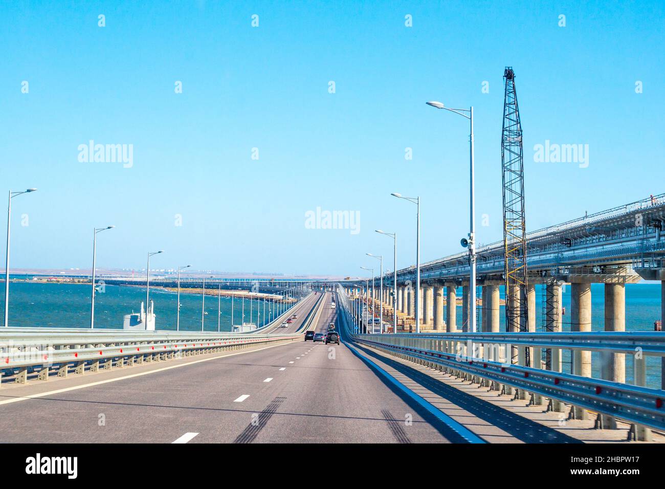 Transport passes over the Crimean bridge in Russia, a railway bridge is ...