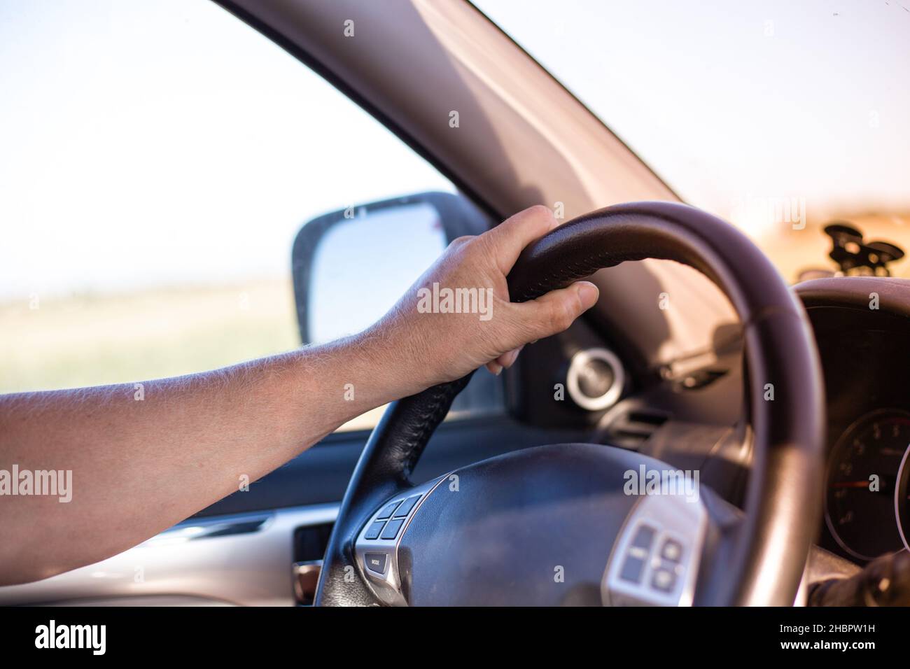 a man drives a car and turns the steering wheel Stock Photo - Alamy