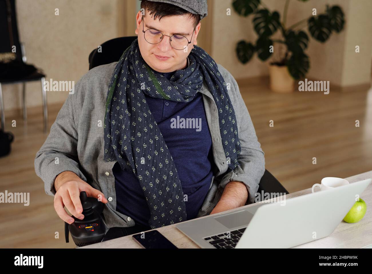 Man with disability rotating control panel of his wheelchair while ...