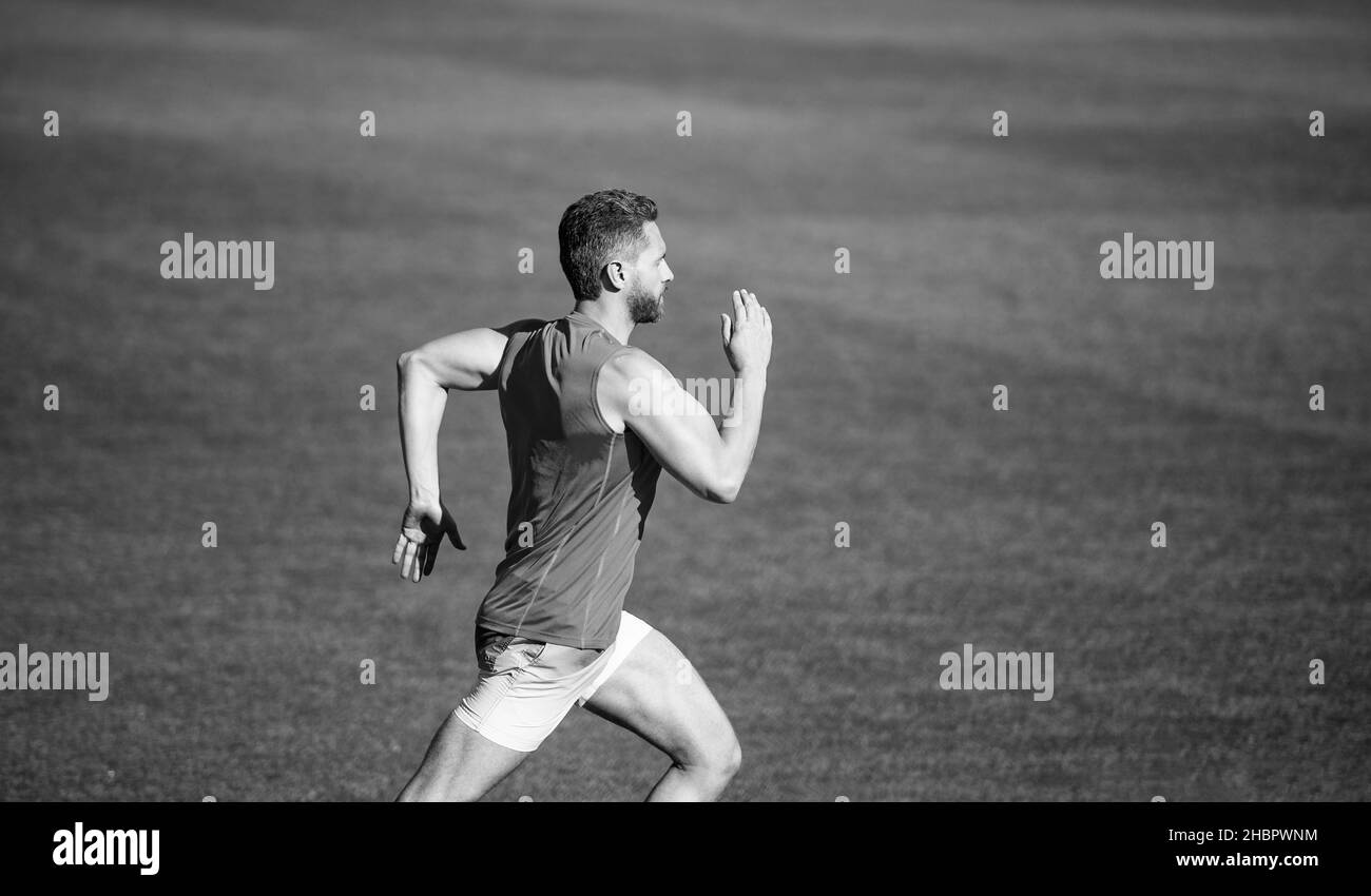 sportsman guy in sportswear run fast sprinting on running track, speed ...