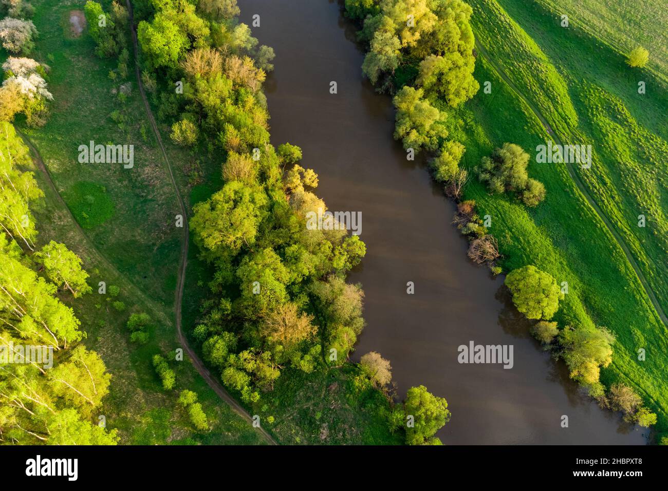 Small river in the middle of green landscape, aerial view Stock Photo ...