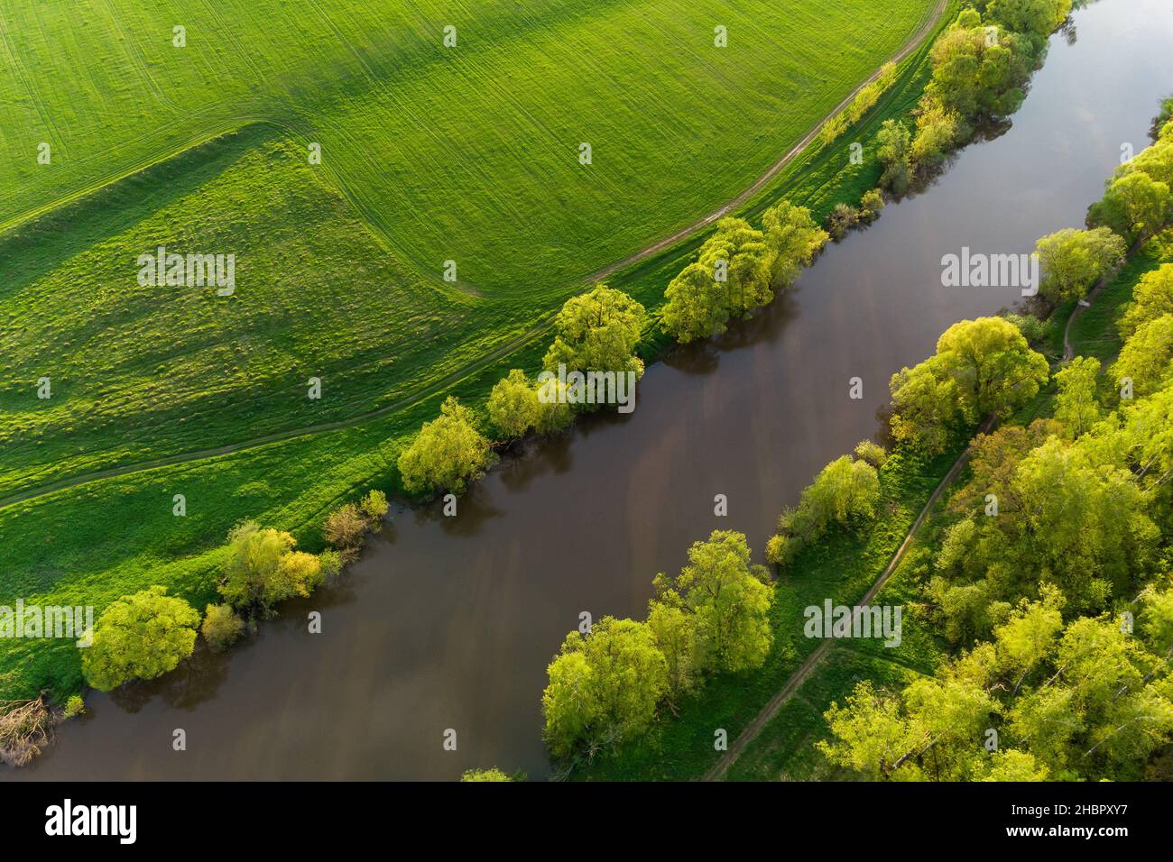 Small river in the middle of green landscape, aerial view Stock Photo ...