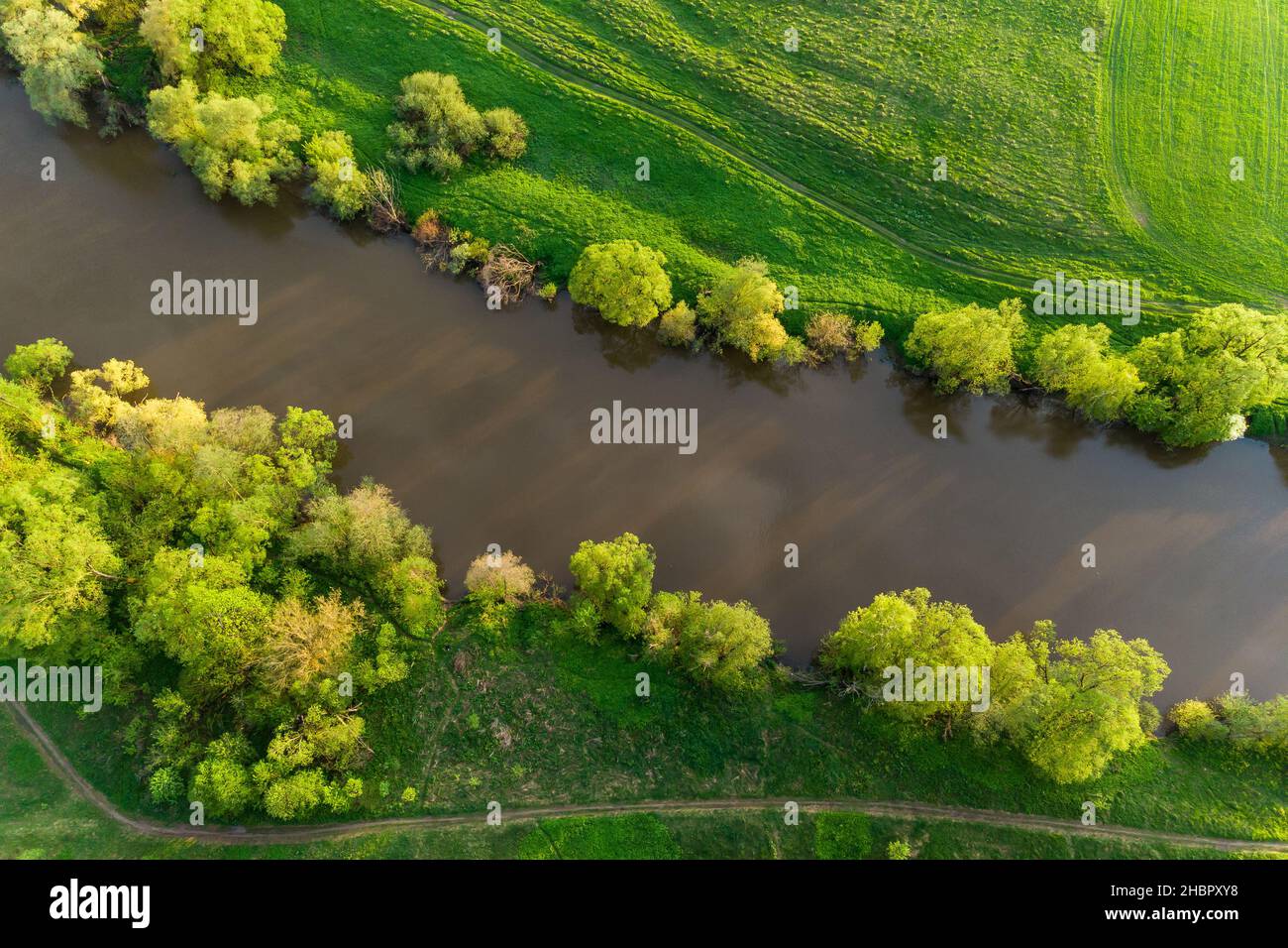 Small river in the middle of green landscape, aerial view Stock Photo ...