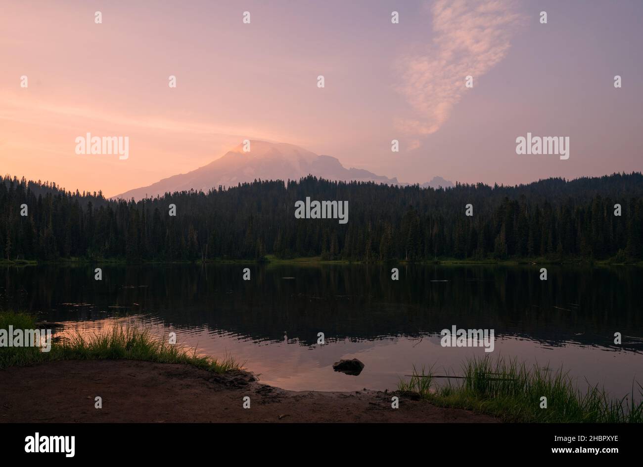 A beautiful view of Mount Rainier National Park with a lake at sunrise ...