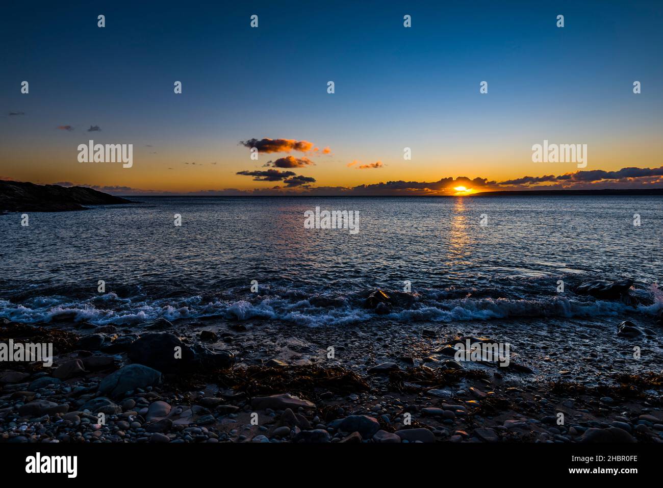 Sun setting below the clouds over Mount's Bay from Trevean Cove near ...