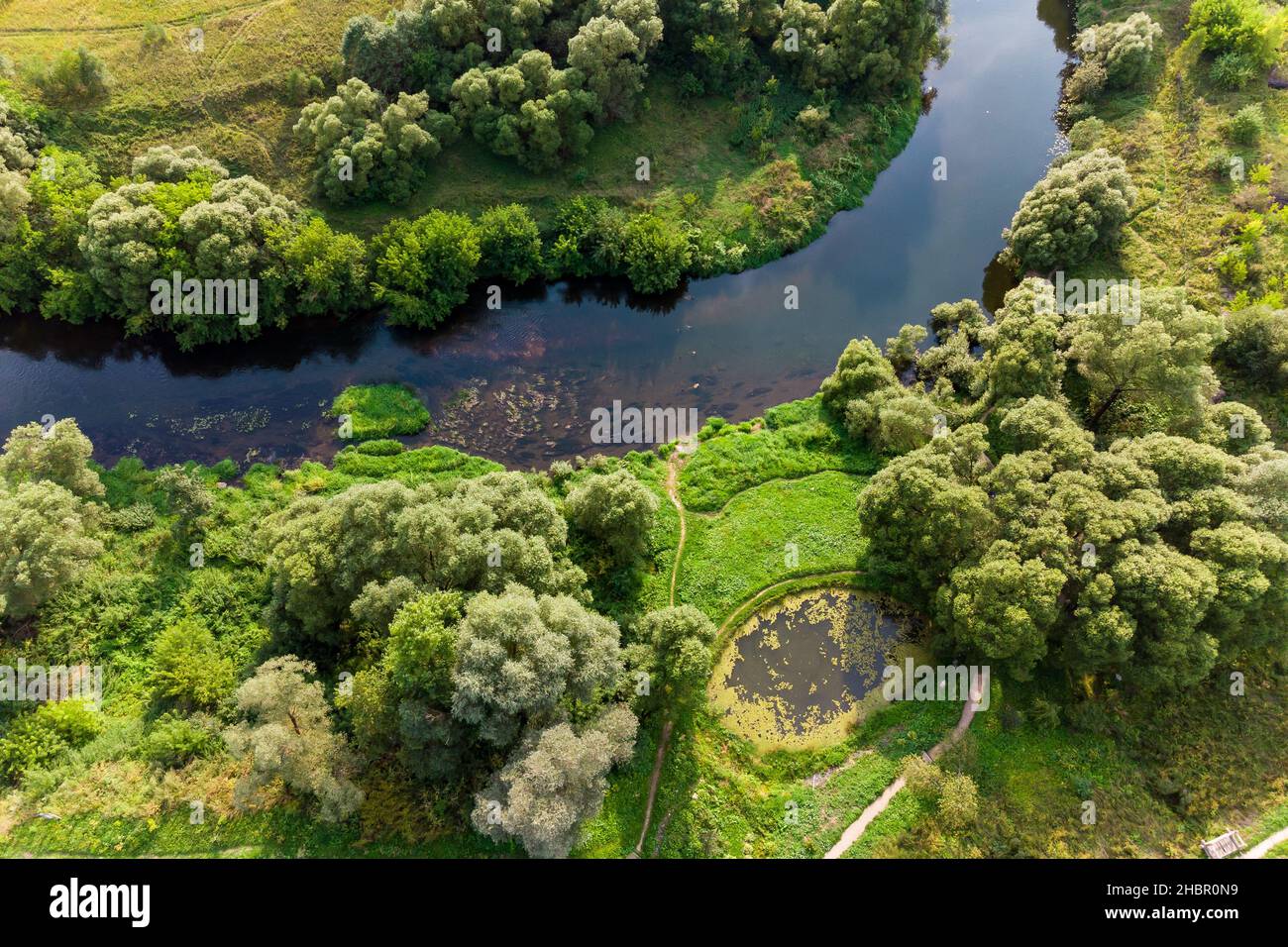 Green landscape with a bend in the river and a small pond, aerial view ...