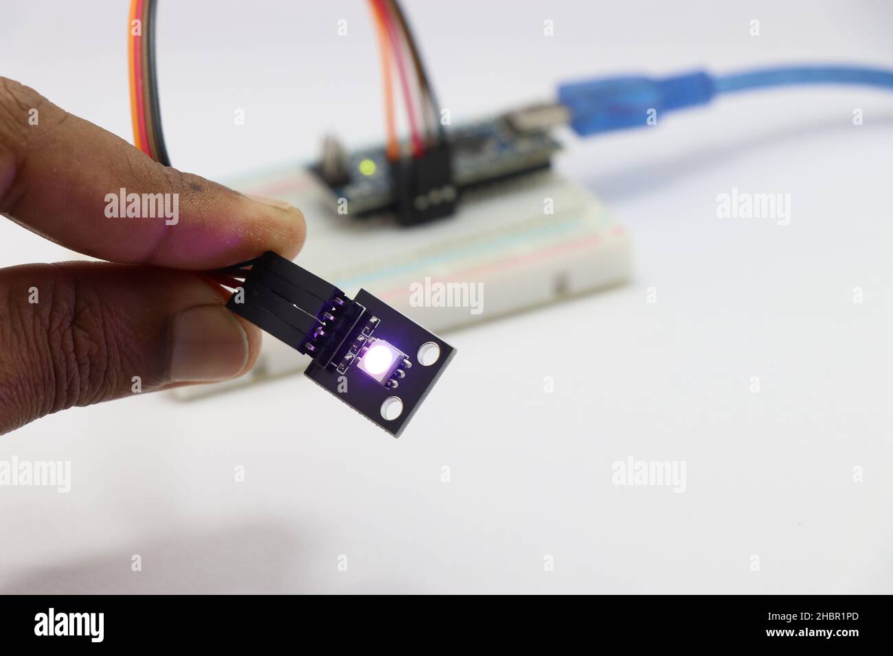 ARGB LED module held in hand connected to micro controller on ...