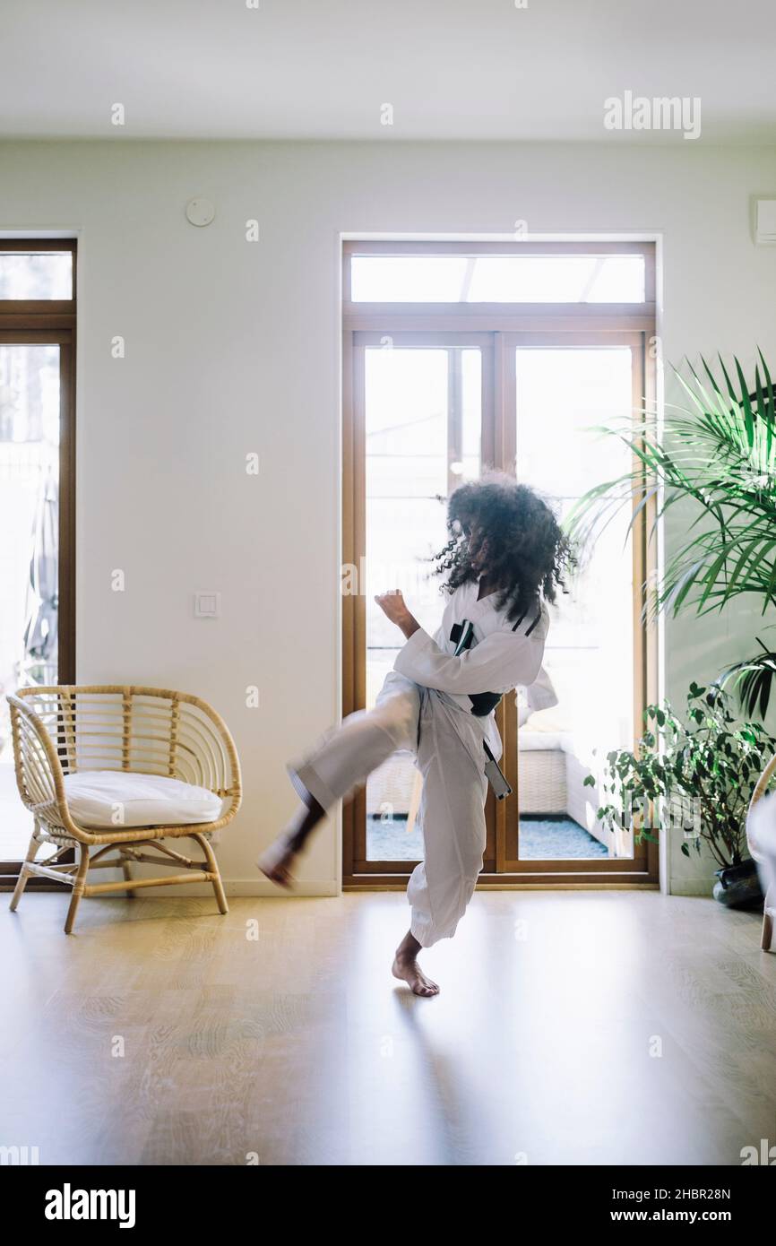 Active girl practicing karate in living room at home Stock Photo - Alamy