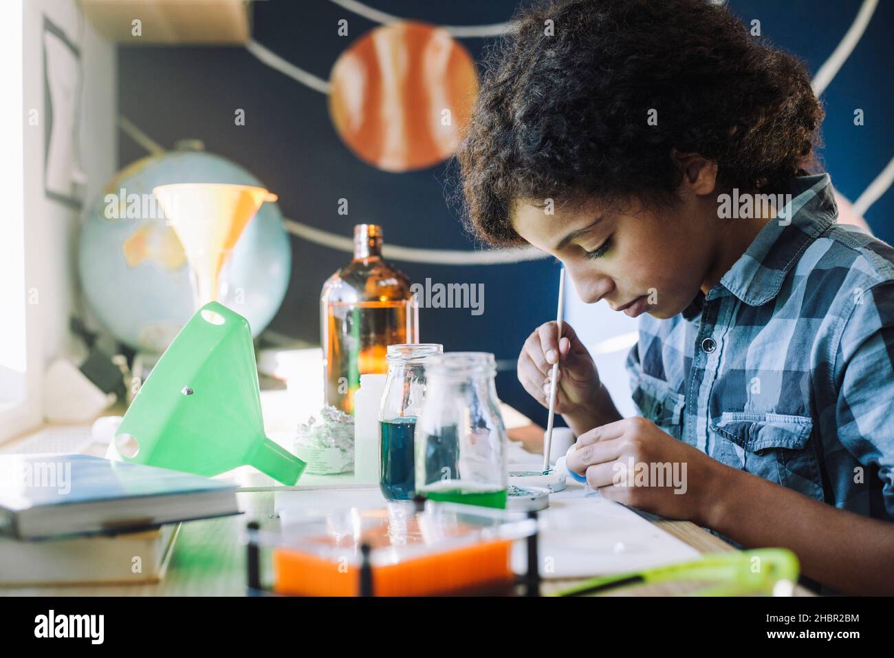 Girl concentrating while doing science project at home Stock Photo - Alamy