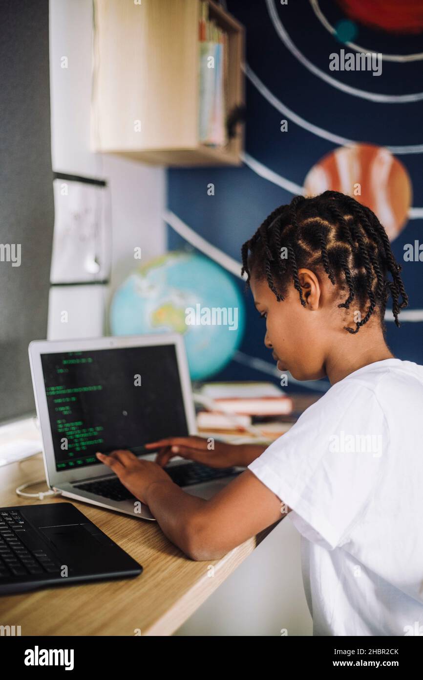 Motivated girl learning coding on laptop at home Stock Photo - Alamy
