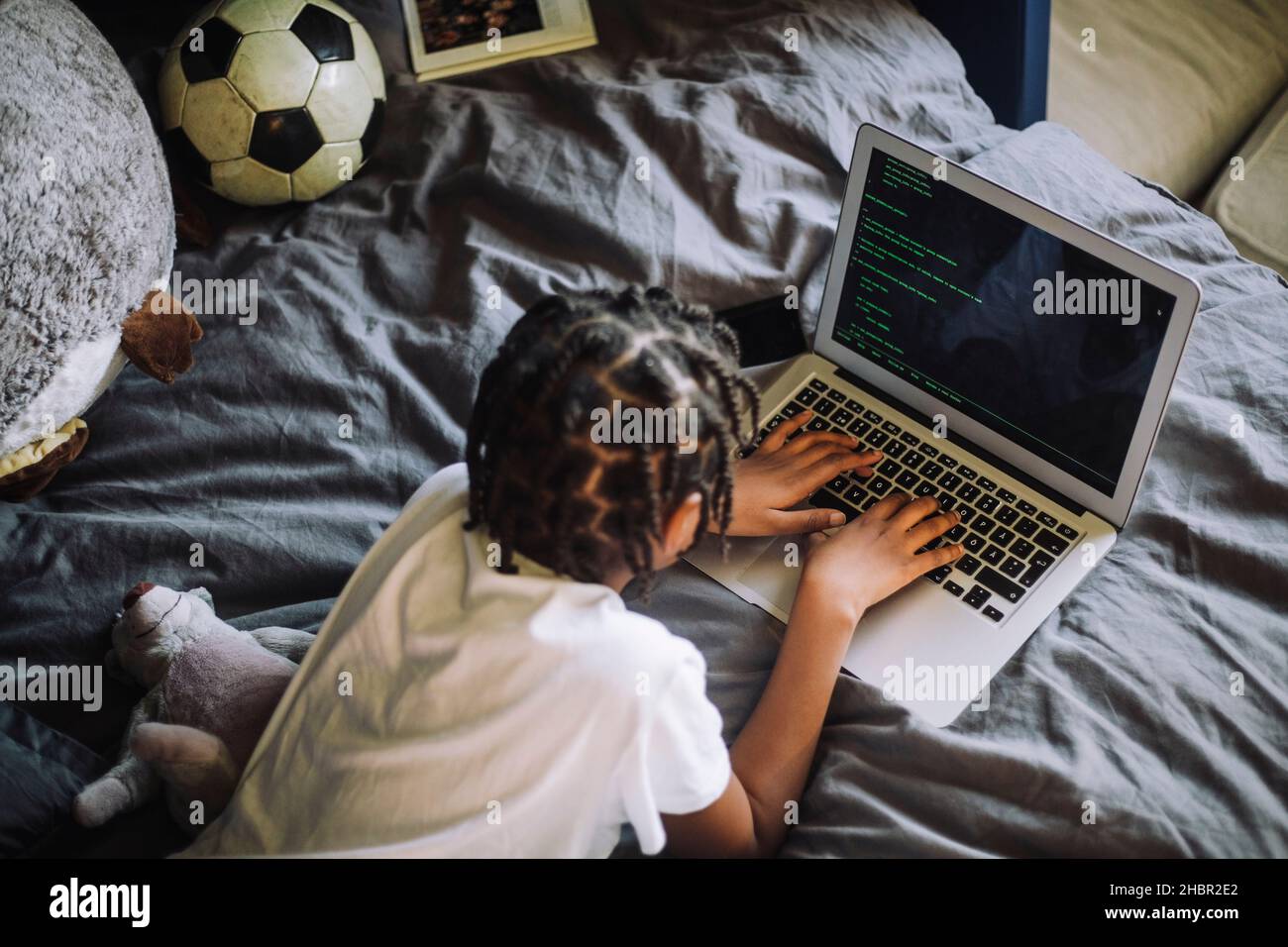 Kid typing laptop hi-res stock photography and images - Alamy