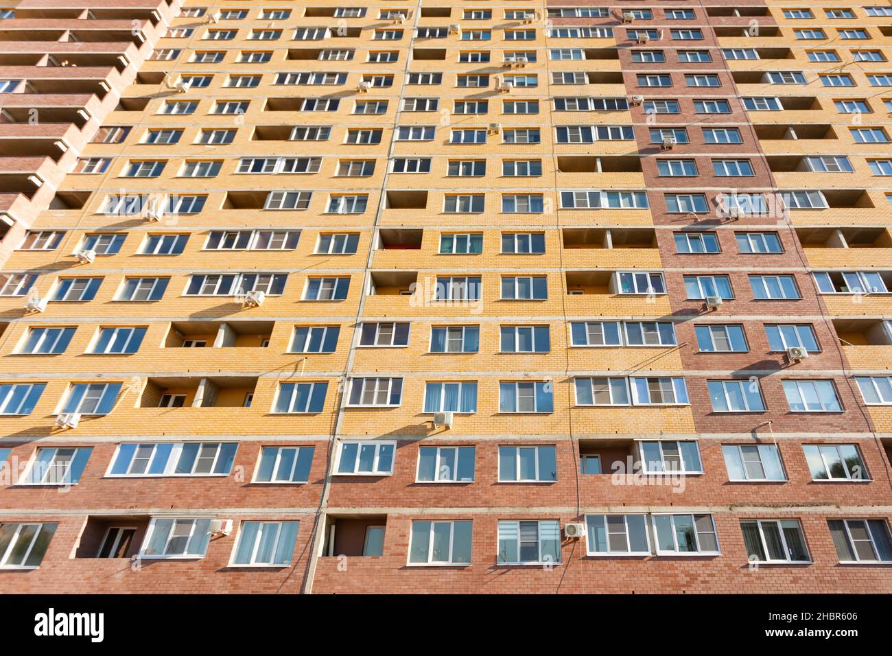 multi-apartment multi-storey brick modern house facade, bottom view ...
