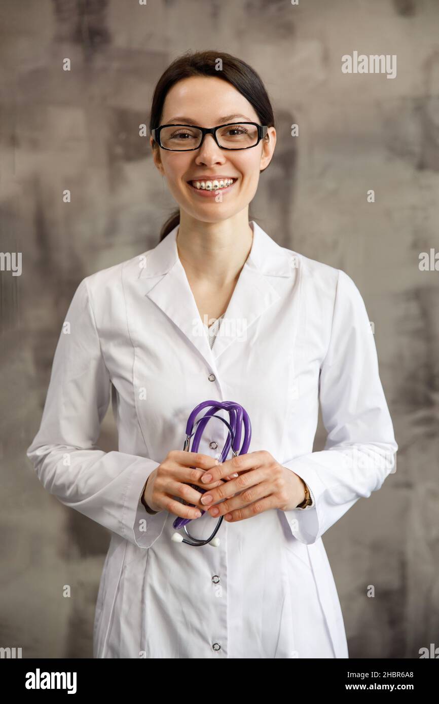 Portrait of a woman doctor with stetoscope looking at camera. Smiling ...