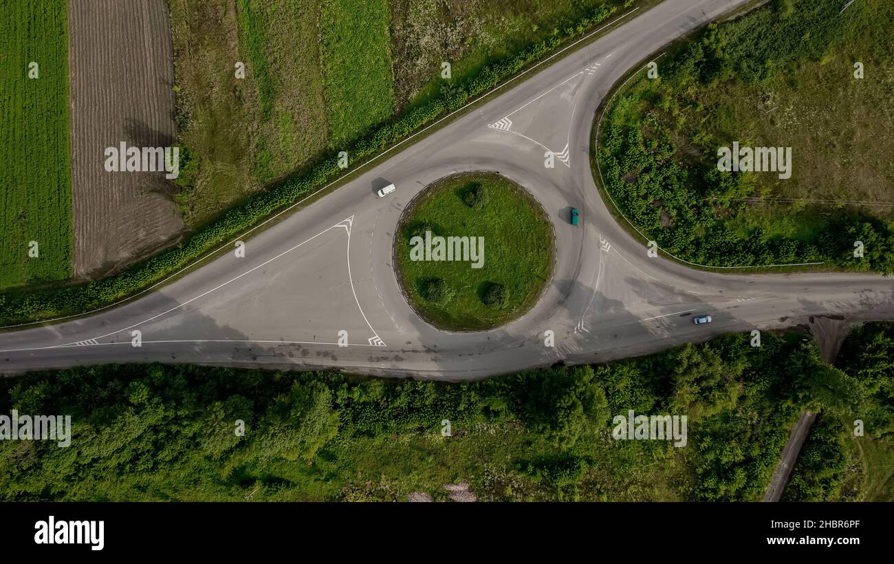 Roundabout traffic of cars and trucks on the circle ring road aerial ...