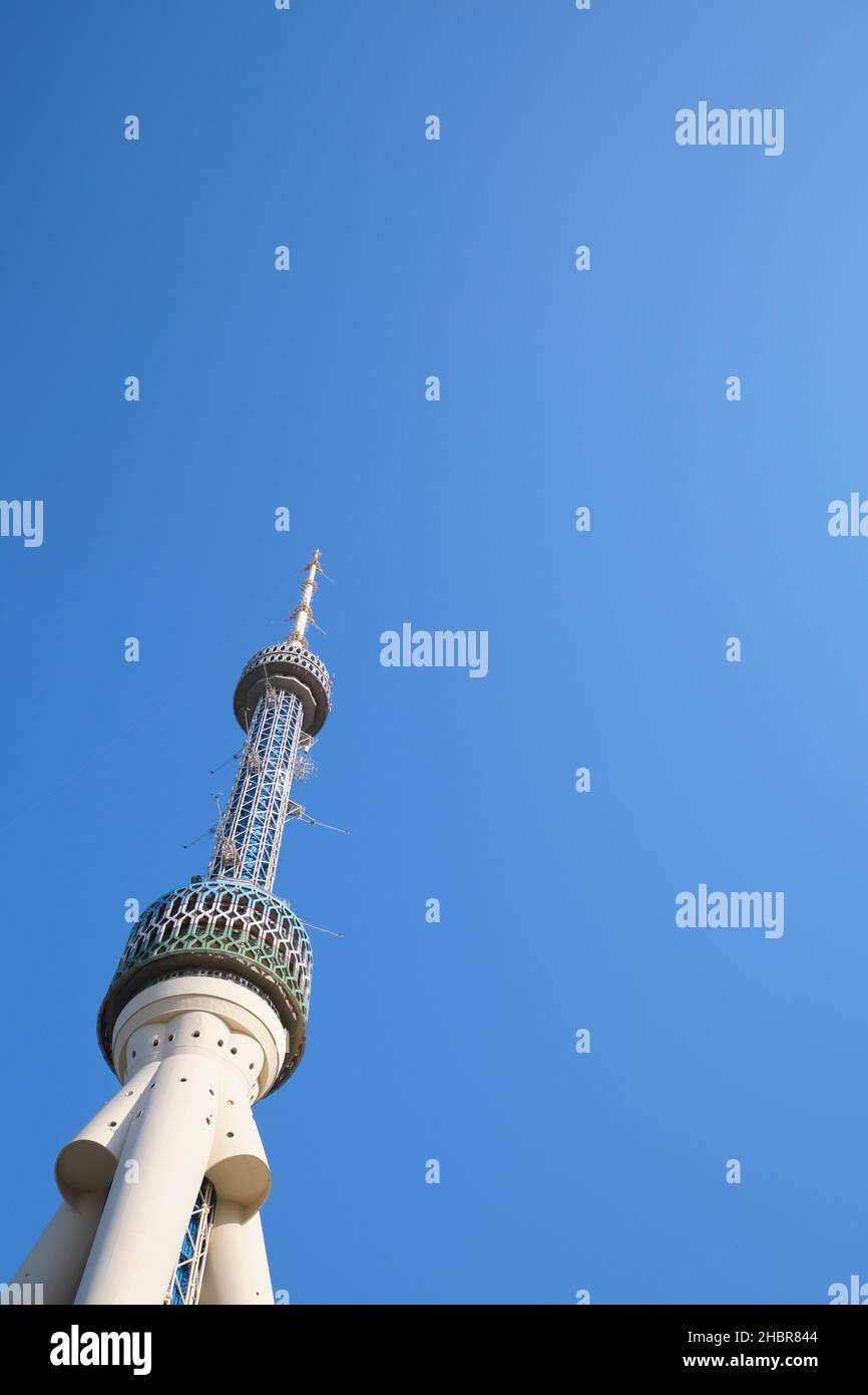 A vertical view of the Tashkent Television Tower with blue sky ...