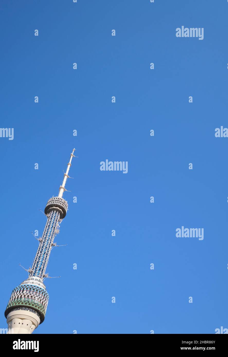 A vertical view of the Tashkent Television Tower with blue sky ...