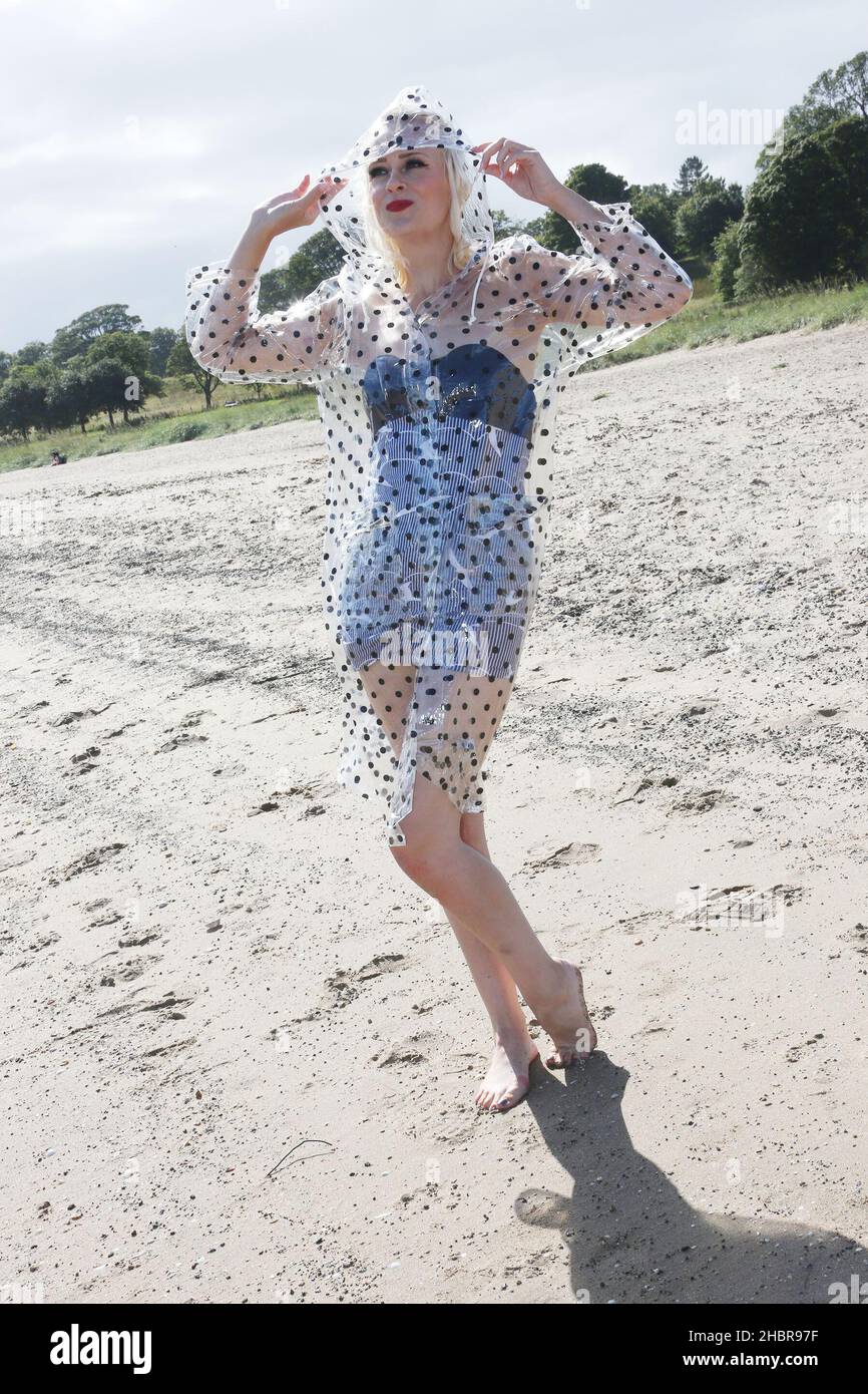 Pretty glamorous young woman dressed in retro 1950s swimsuit worn under ...