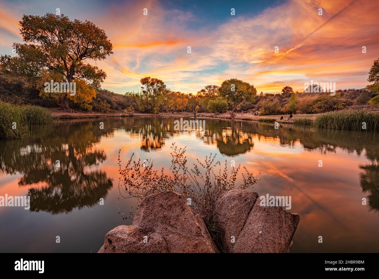 A beautiful view of a lake with the reflection of surrounding trees and ...