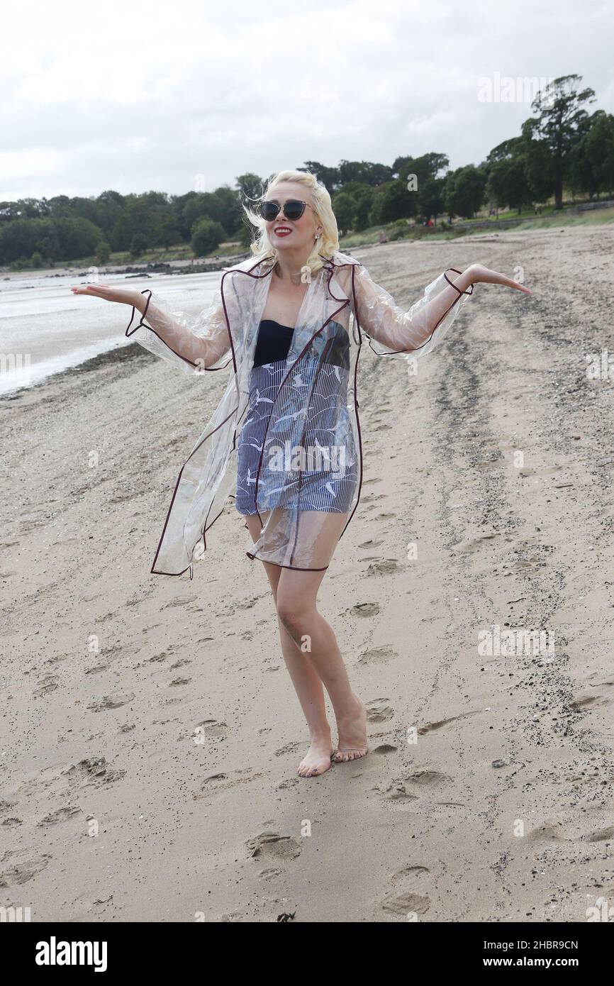 Pretty glamorous young woman dressed in retro 1950s swimsuit worn under ...