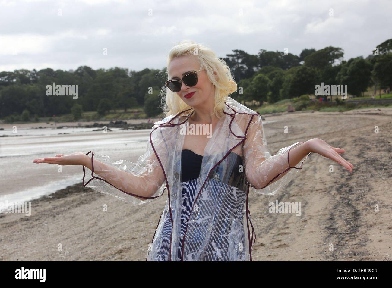 Pretty glamorous young woman dressed in retro 1950s swimsuit worn under ...