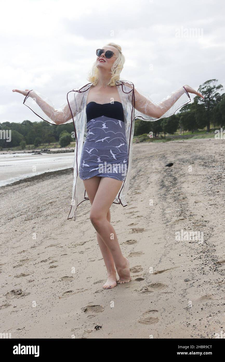 Pretty glamorous young woman dressed in retro 1950s swimsuit worn under ...