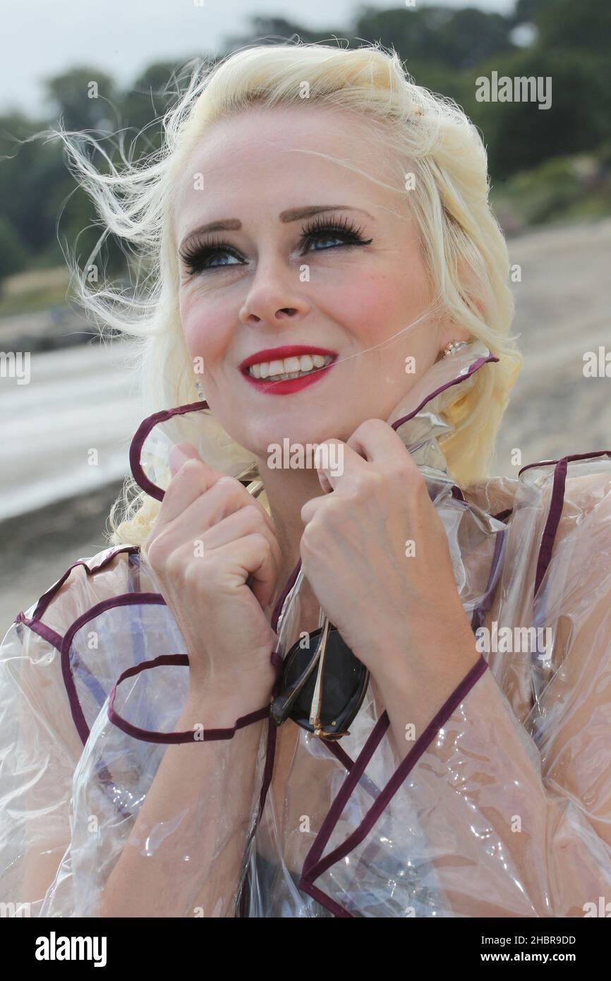 Pretty glamorous young woman dressed in retro 1950s swimsuit worn under ...