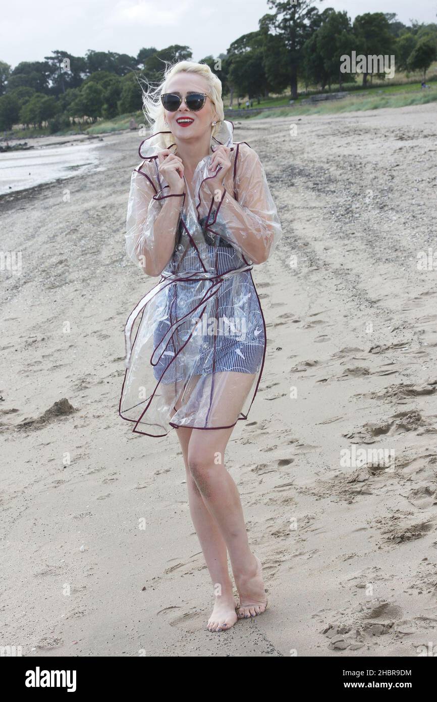 Pretty glamorous young woman dressed in retro 1950s swimsuit worn under ...