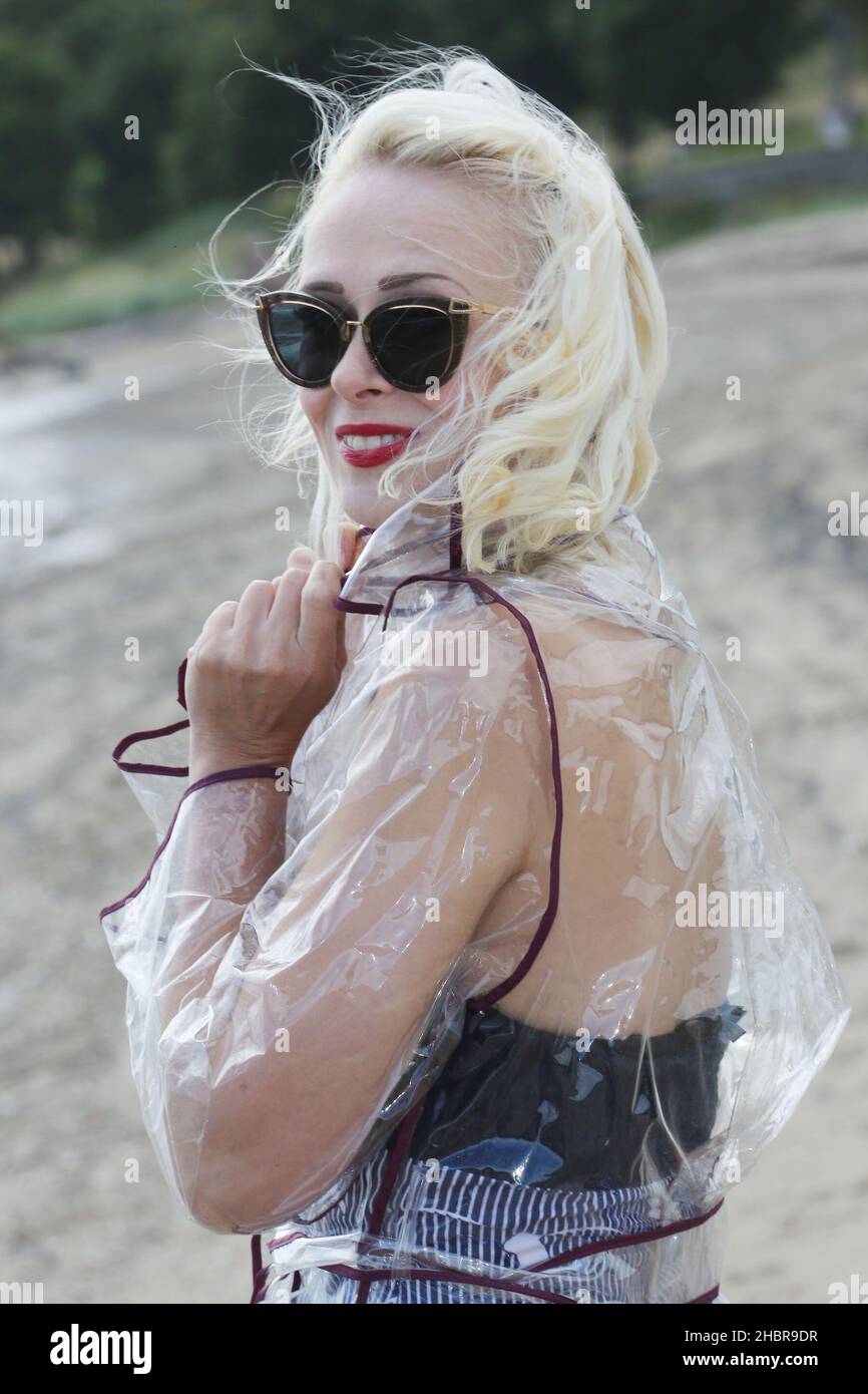 Pretty glamorous young woman dressed in retro 1950s swimsuit worn under ...