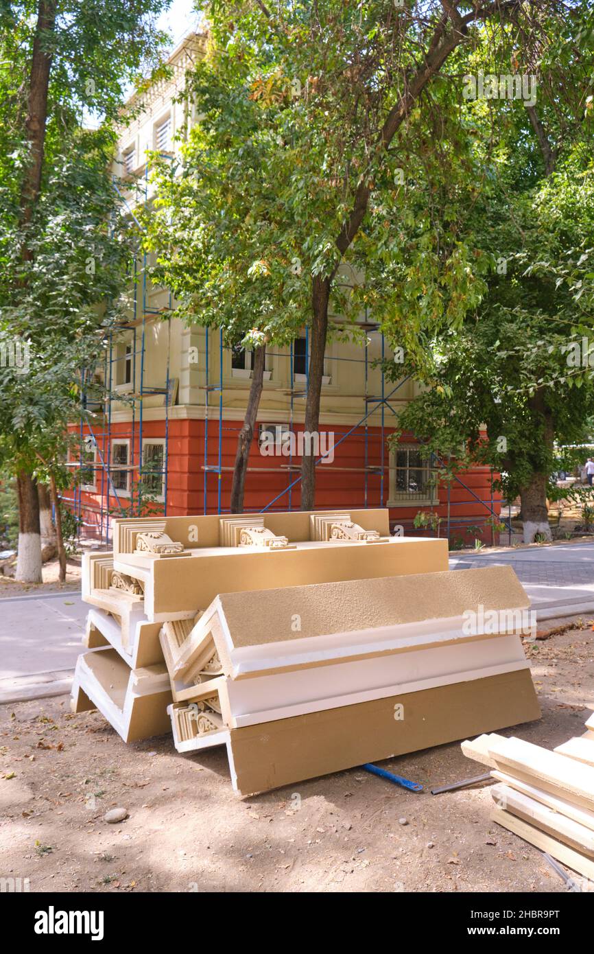 An old Soviet, Russian apartment building being covered in orange and ...