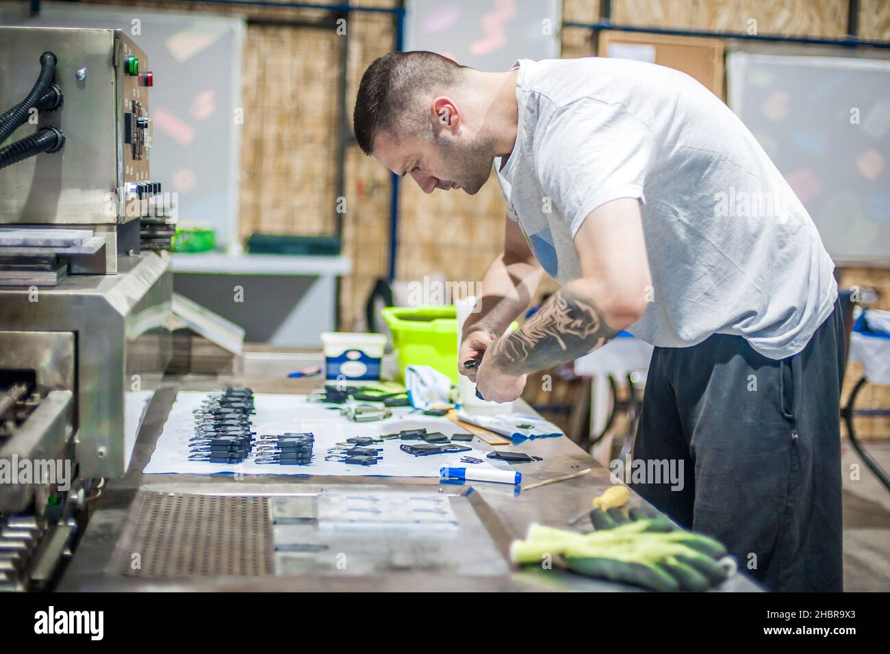 Refrigerator Magnets. Professional worker technician making magnet for ...