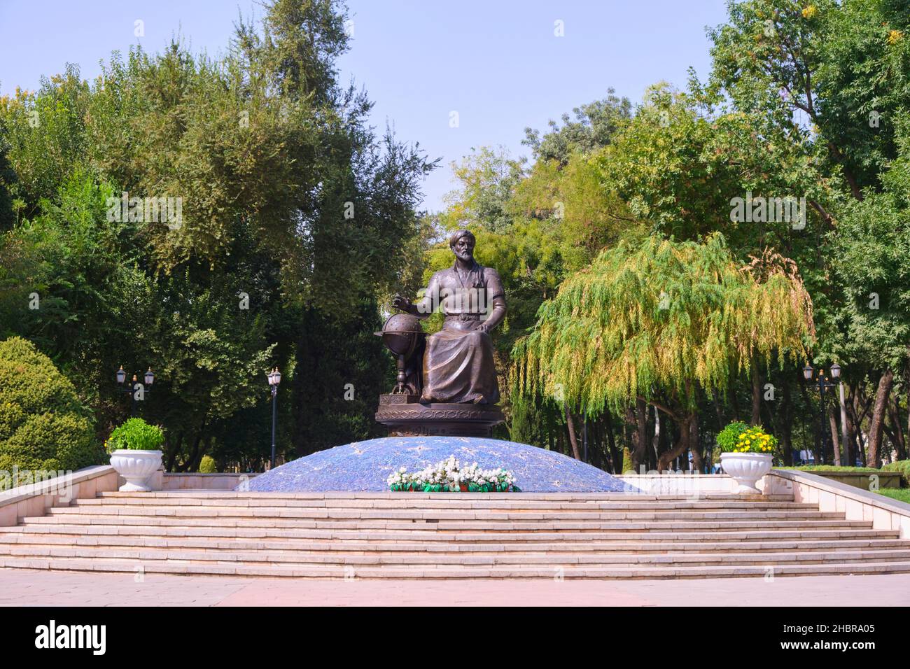 A bronze statue of the famous astronomer Mirzo Ulugbek with a globe. In ...