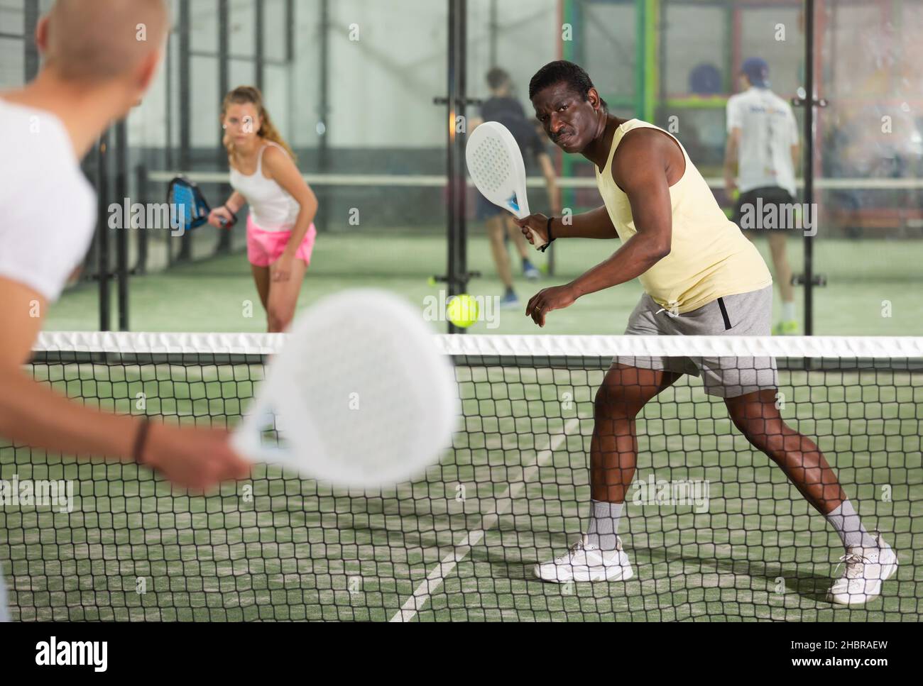 Portrait of concentrated african american paddle tennis player ...