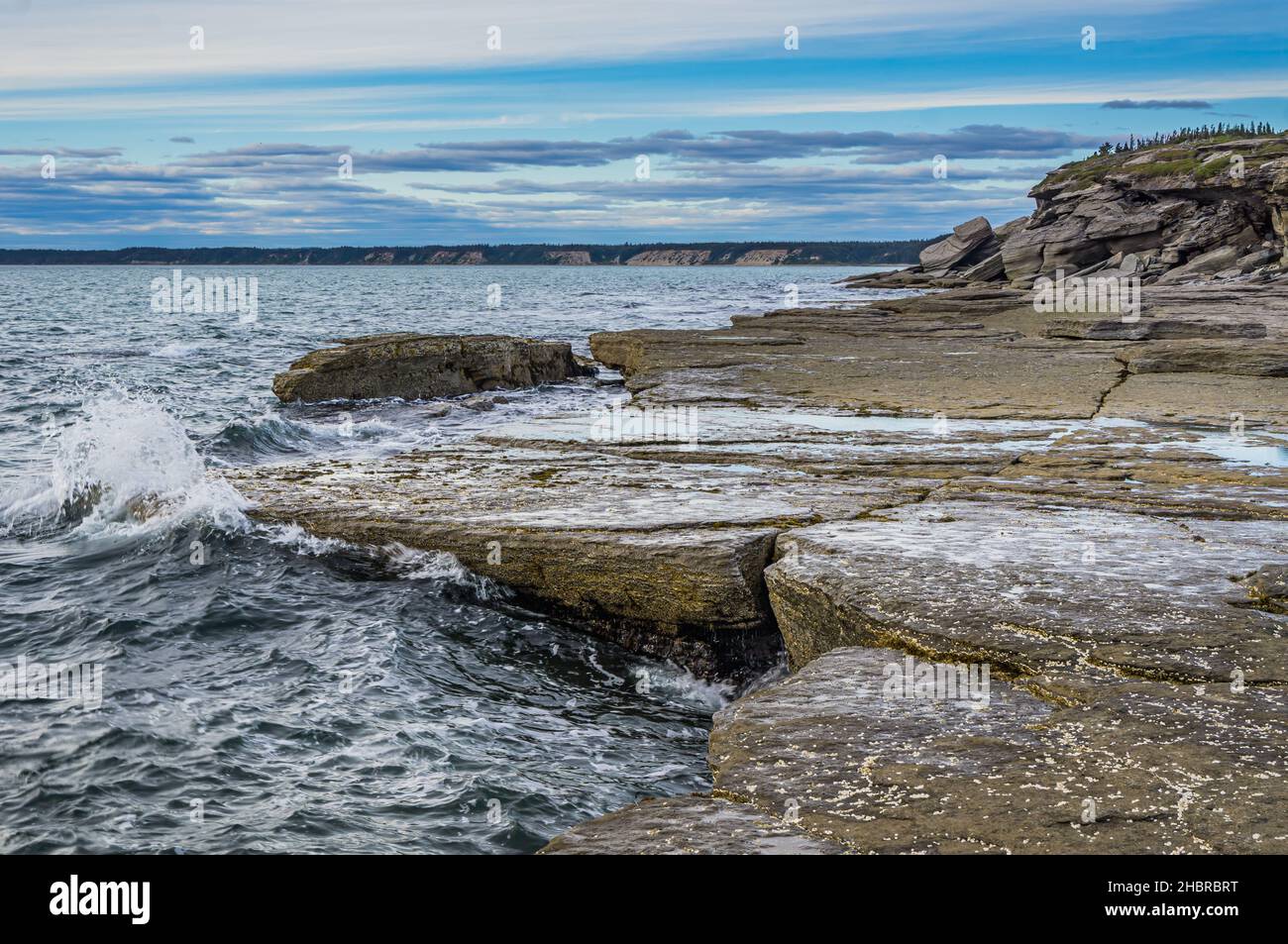 the rugged shoreline of the St Lawrence estuary, with rocky formations ...