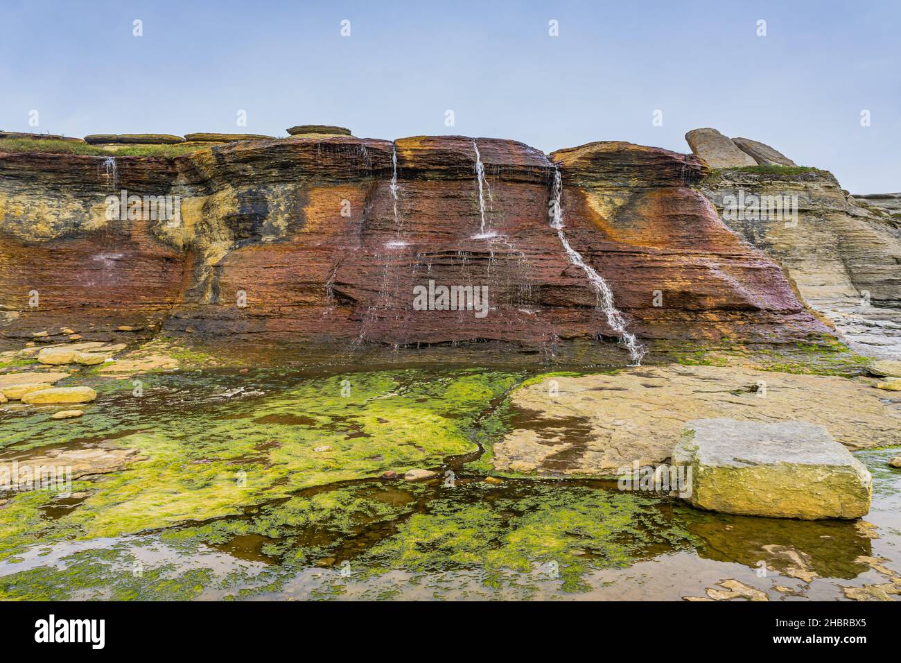 View on the Cap Ferre waterfall, a small waterfall rich in iron (thus ...