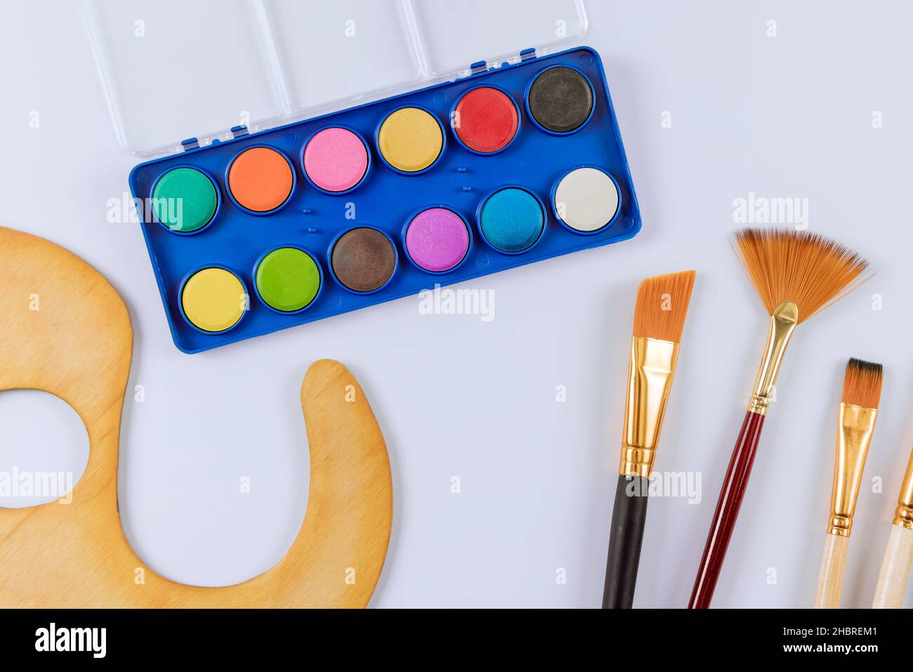 Different artistic tools with wooden art palette a painting brushes ...