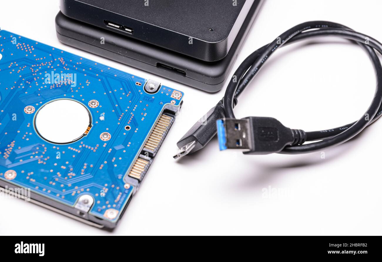 Portable external hard disc drives with USB 3.0 cable on white ...