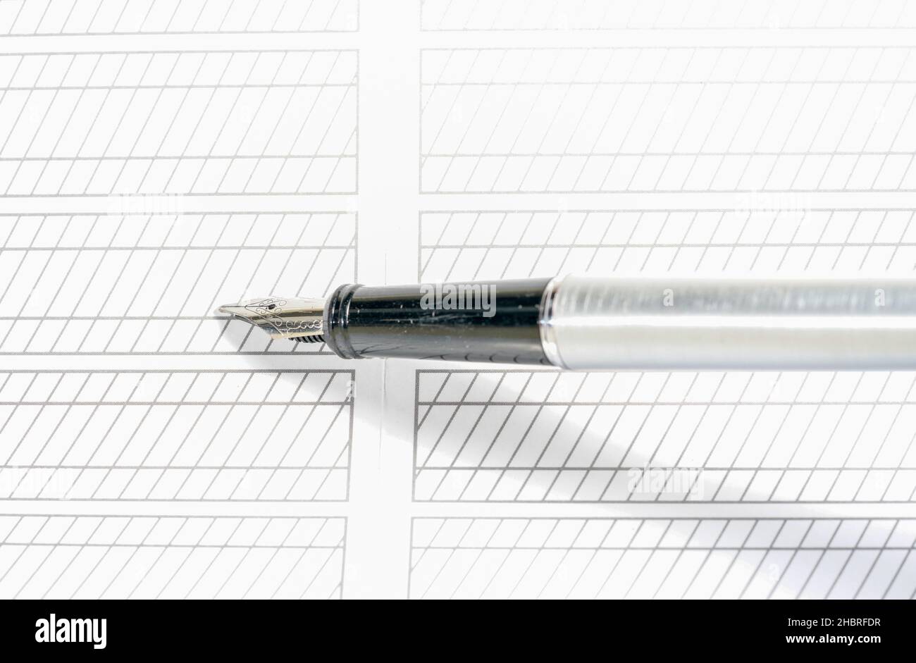 A closeup shot of a pen drawing geometric lines on a white paper Stock ...