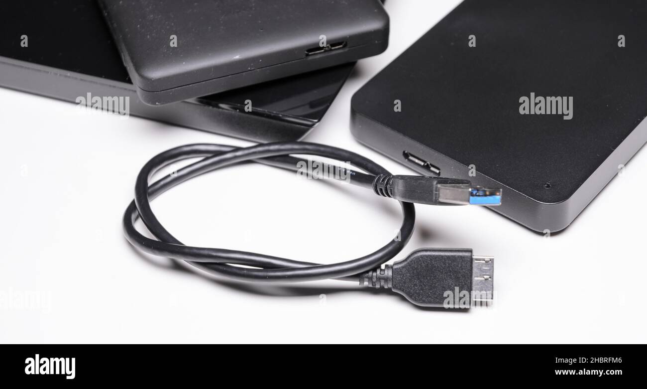 Portable external hard disc drives with USB 3.0 cable on white ...