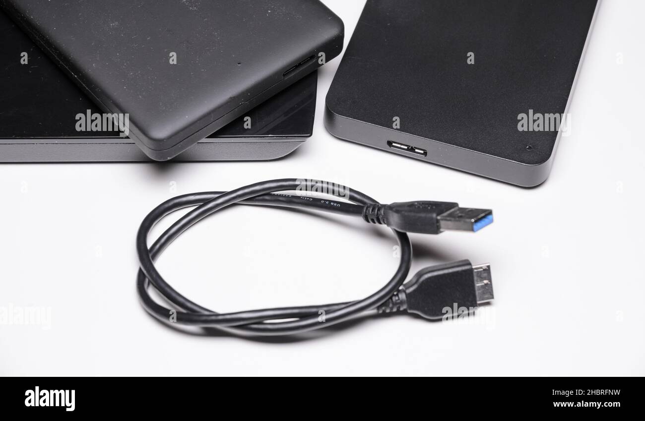 Portable external hard disc drives with USB 3.0 cable on white ...