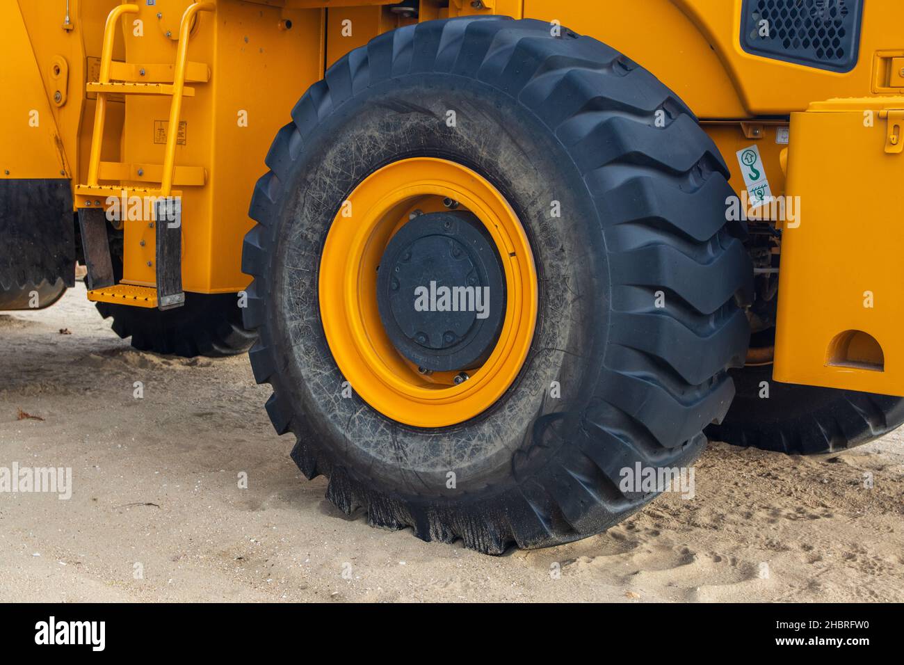A yellow wheel loader at the beach Stock Photo - Alamy