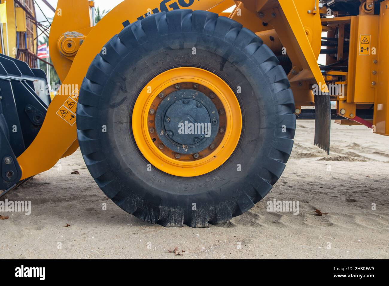 A yellow wheel loader at the beach Stock Photo - Alamy